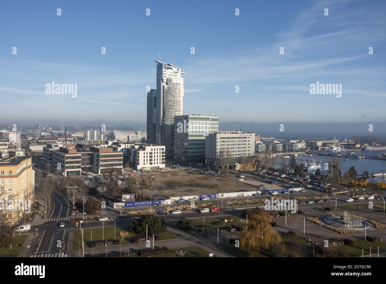 Urban landscape featuring a tall skyscraper near the waterfront. The ...
