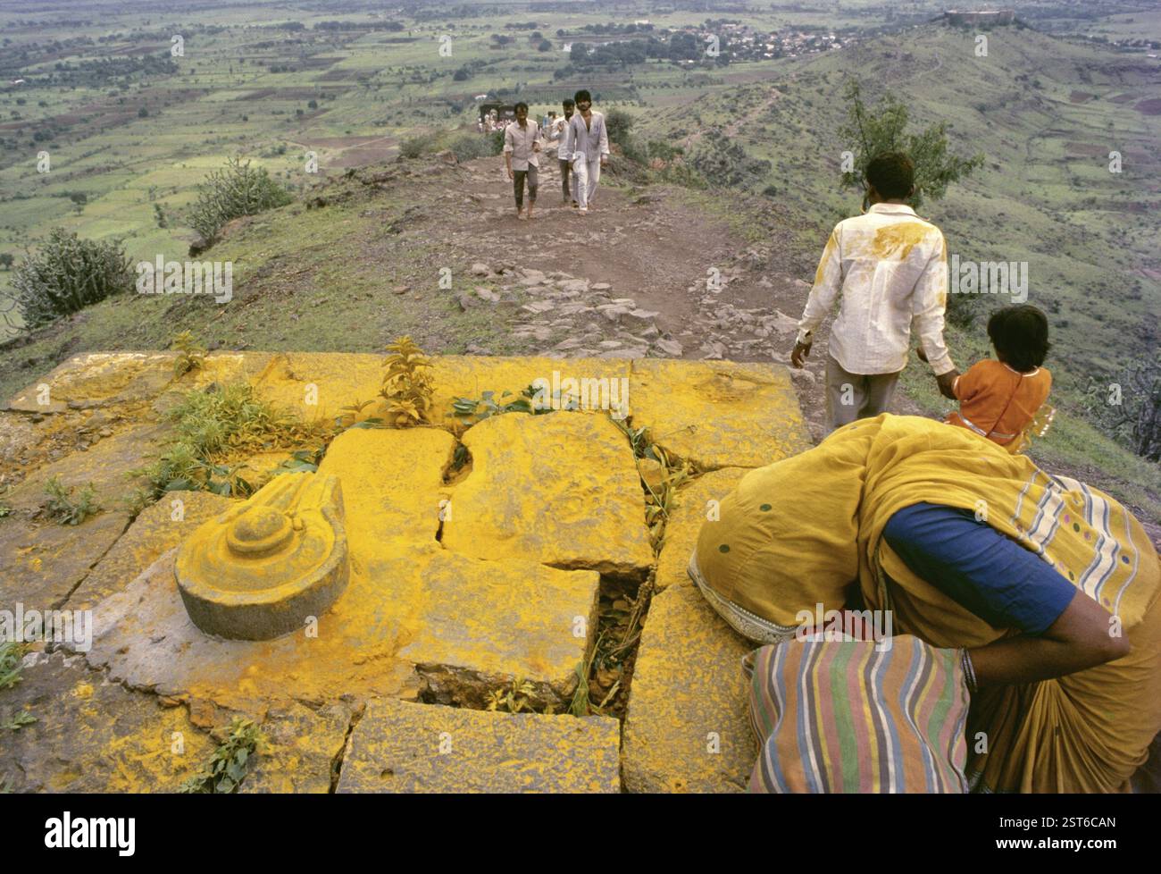 Showing her respect a woman bows her head at a shrine. Every small ...