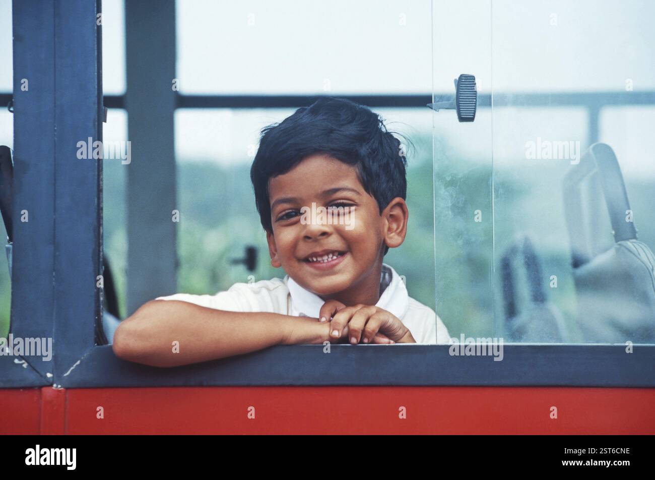Child looking out of a bus window Stock Photo - Alamy