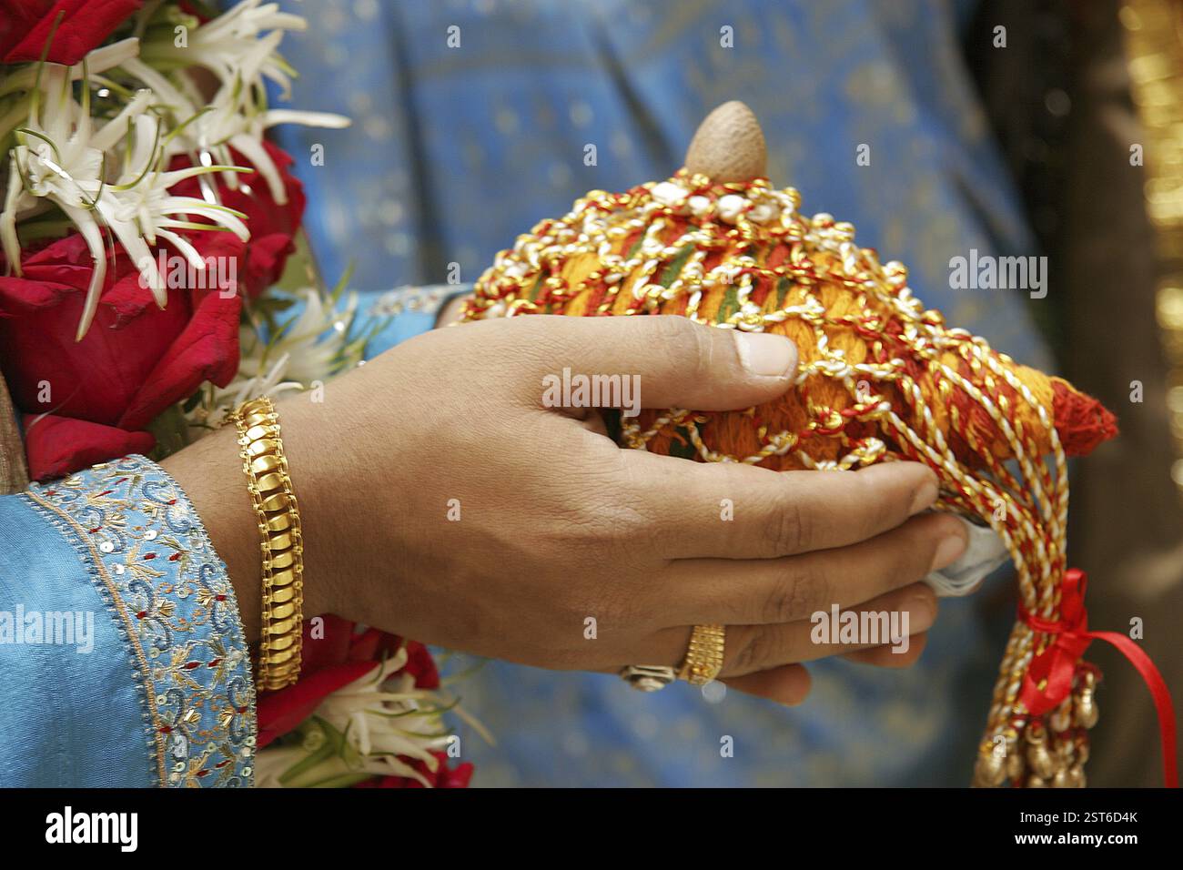 An Indian Gujarati Groom holding a decorated dried coconut during his ...