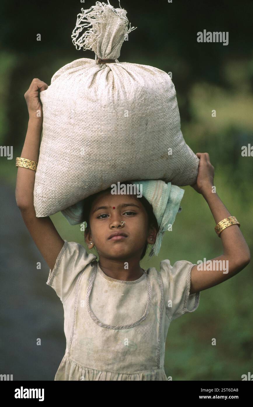 Girl holding jute bag on head NO MR Stock Photo - Alamy