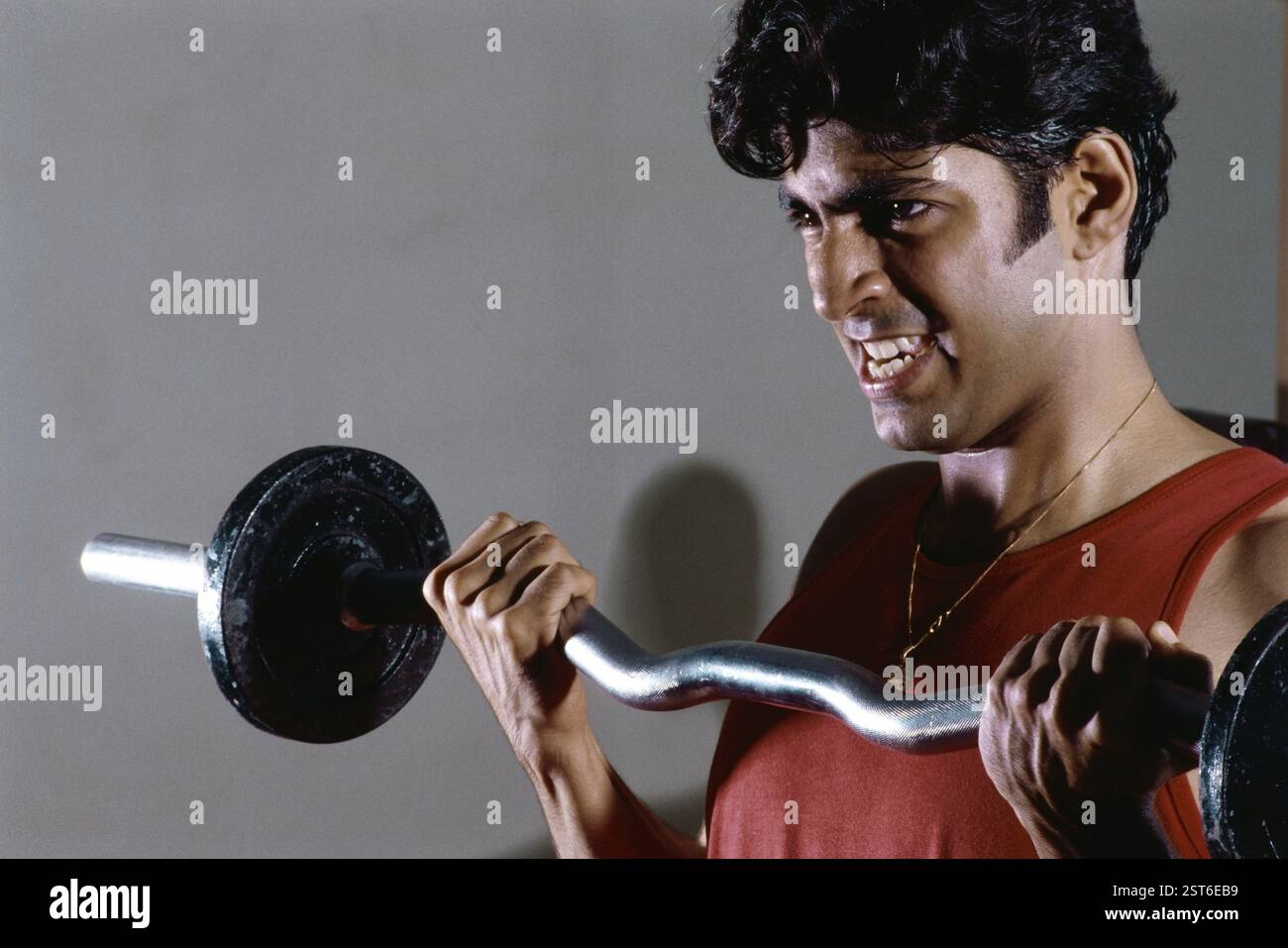 Man doing exercise using weight equipment MR#139 Stock Photo - Alamy