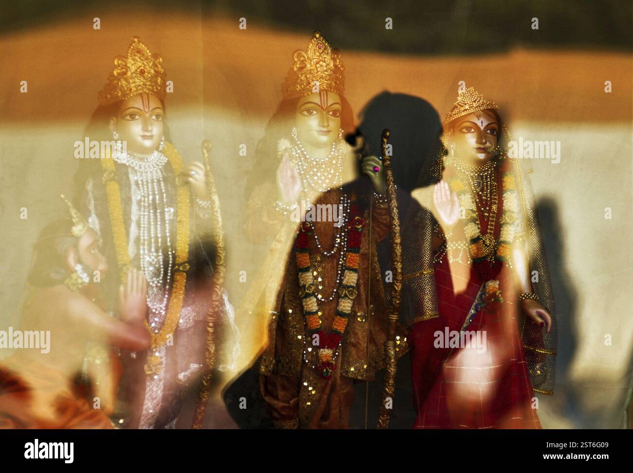 An Isckon Lord Krishna devotee passes by an image of Ram, Sita and ...