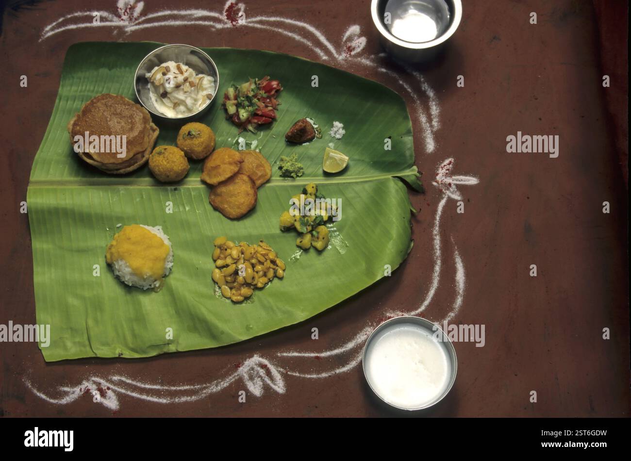 Traditional Indian Meal served on banana leaf Stock Photo - Alamy