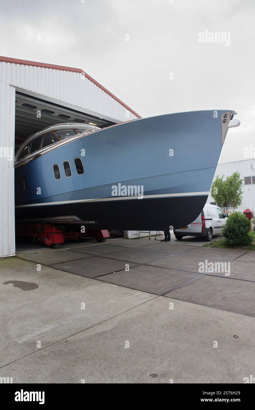 At the shipyard. Blue yacht ready for launch at the yard. Shipbuilding ...