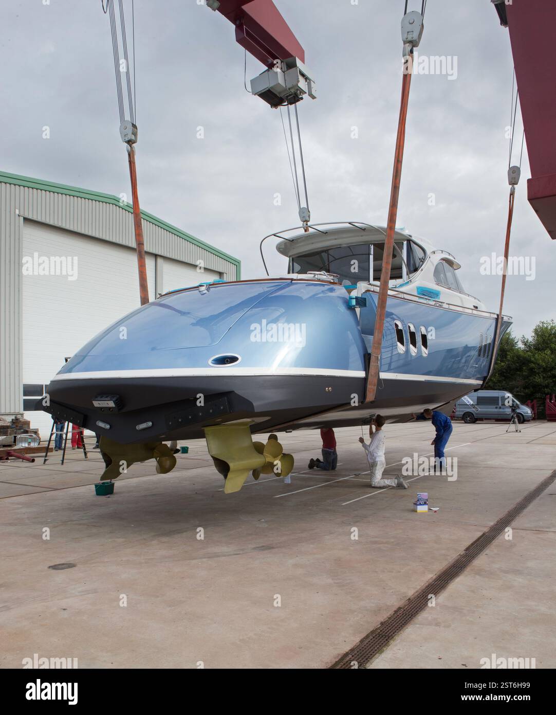 At the shipyard. Blue yacht ready for launch at the yard. Shipbuilding ...
