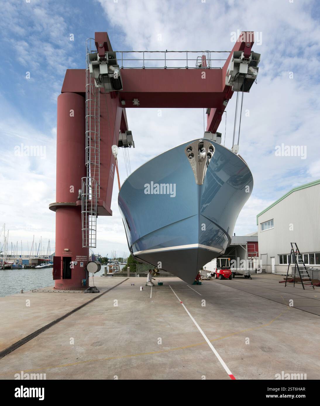 At the shipyard. Blue yacht ready for launch at the yard. Shipbuilding ...