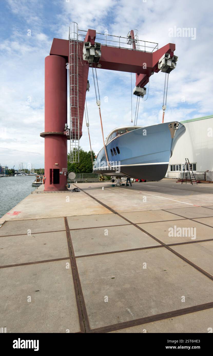 At the shipyard. Blue yacht ready for launch at the yard. Shipbuilding ...