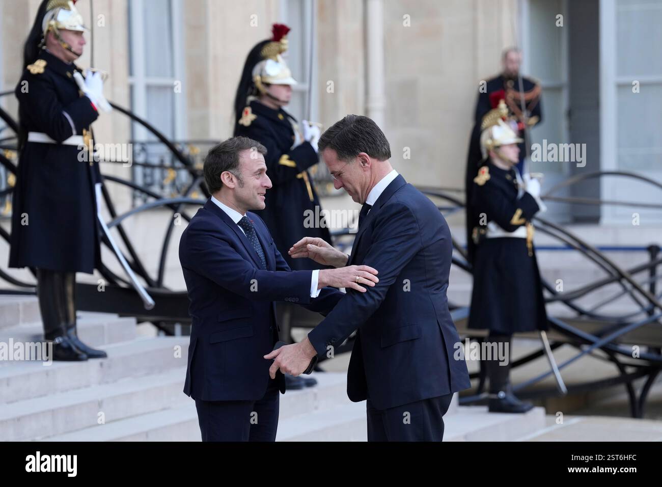 French President Emmanuel Macron, left, greets NATO Secretary General ...