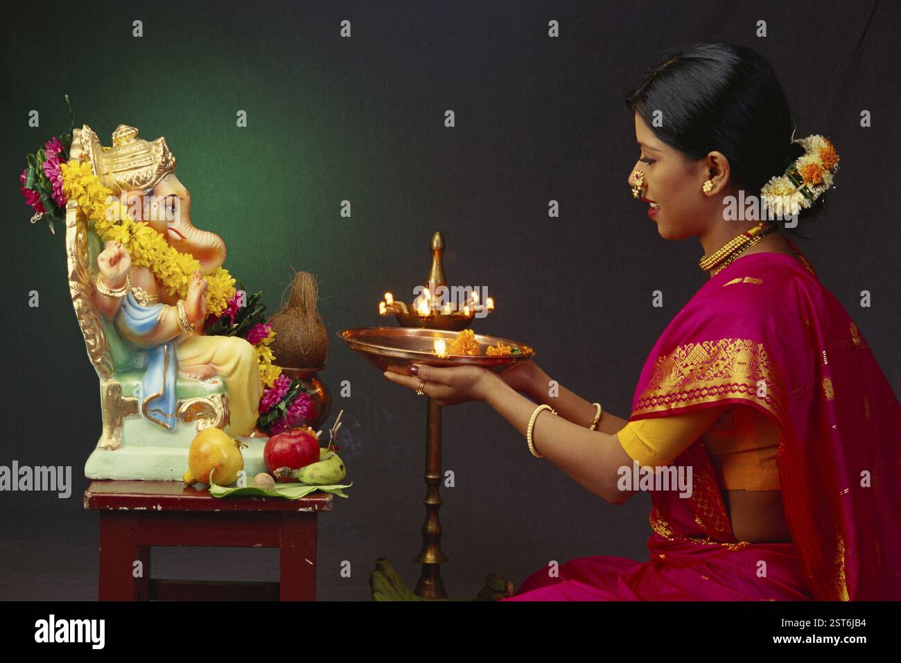 Woman performing pooja puja of lord Ganesh ganpati Festival Elephant ...