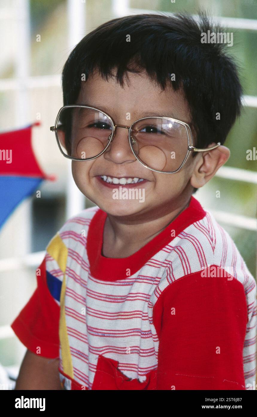 South Asian Indian boy wearing grandfather's spectacles glasses MR ...