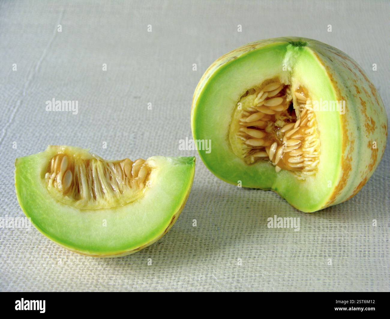 One open cut sweet melon, fruit food juicy tasty round circular table ...