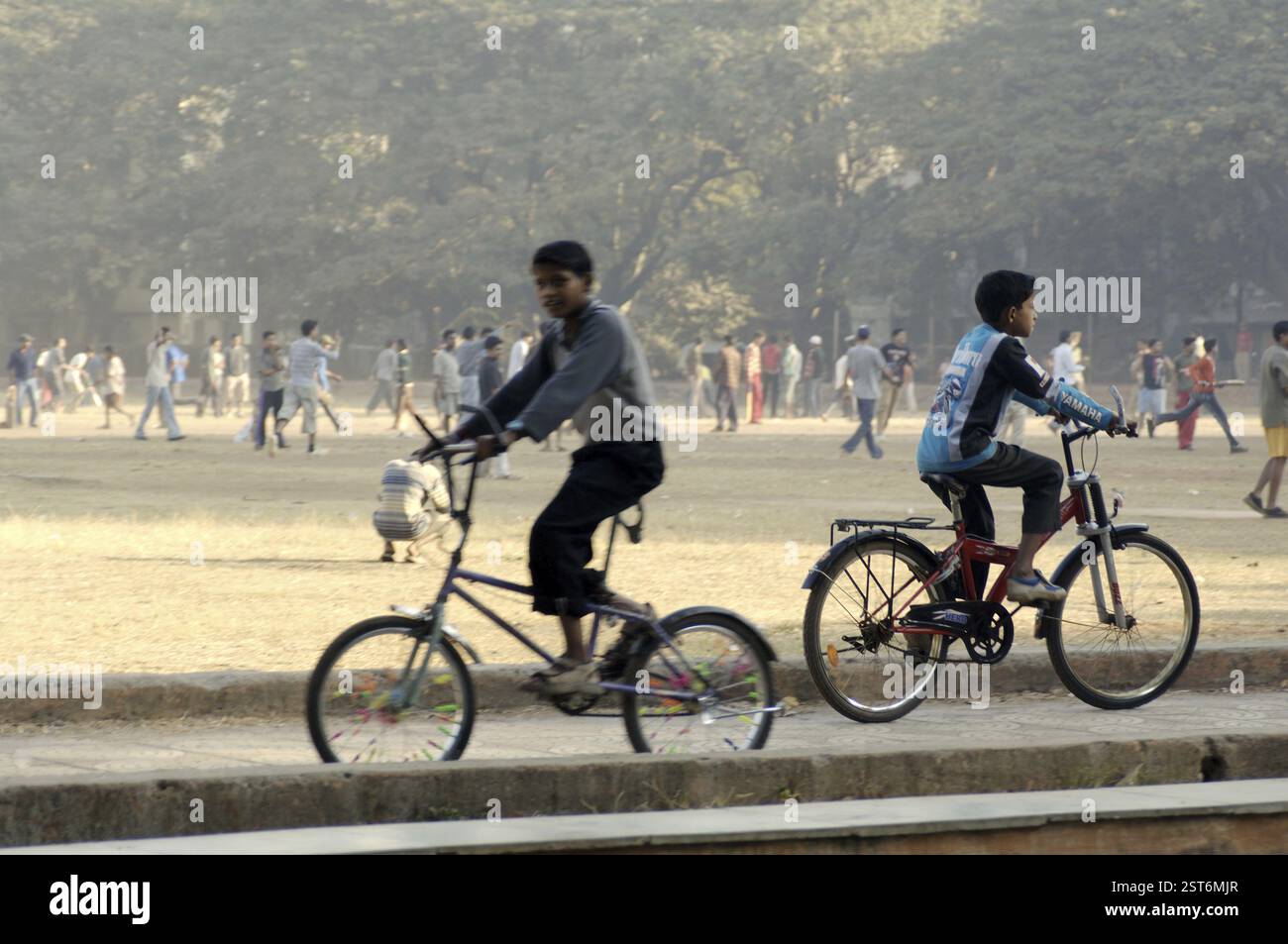 Indian boys riding bicycles on playground, Bombay Mumbai, Maharashtra ...