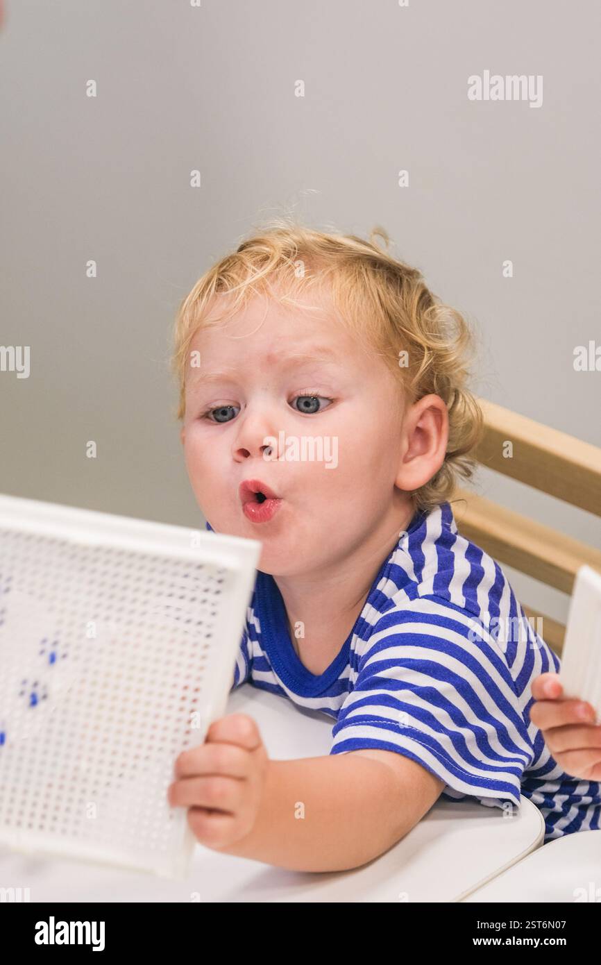 A child collects a puzzle for the development of fine motor skills ...