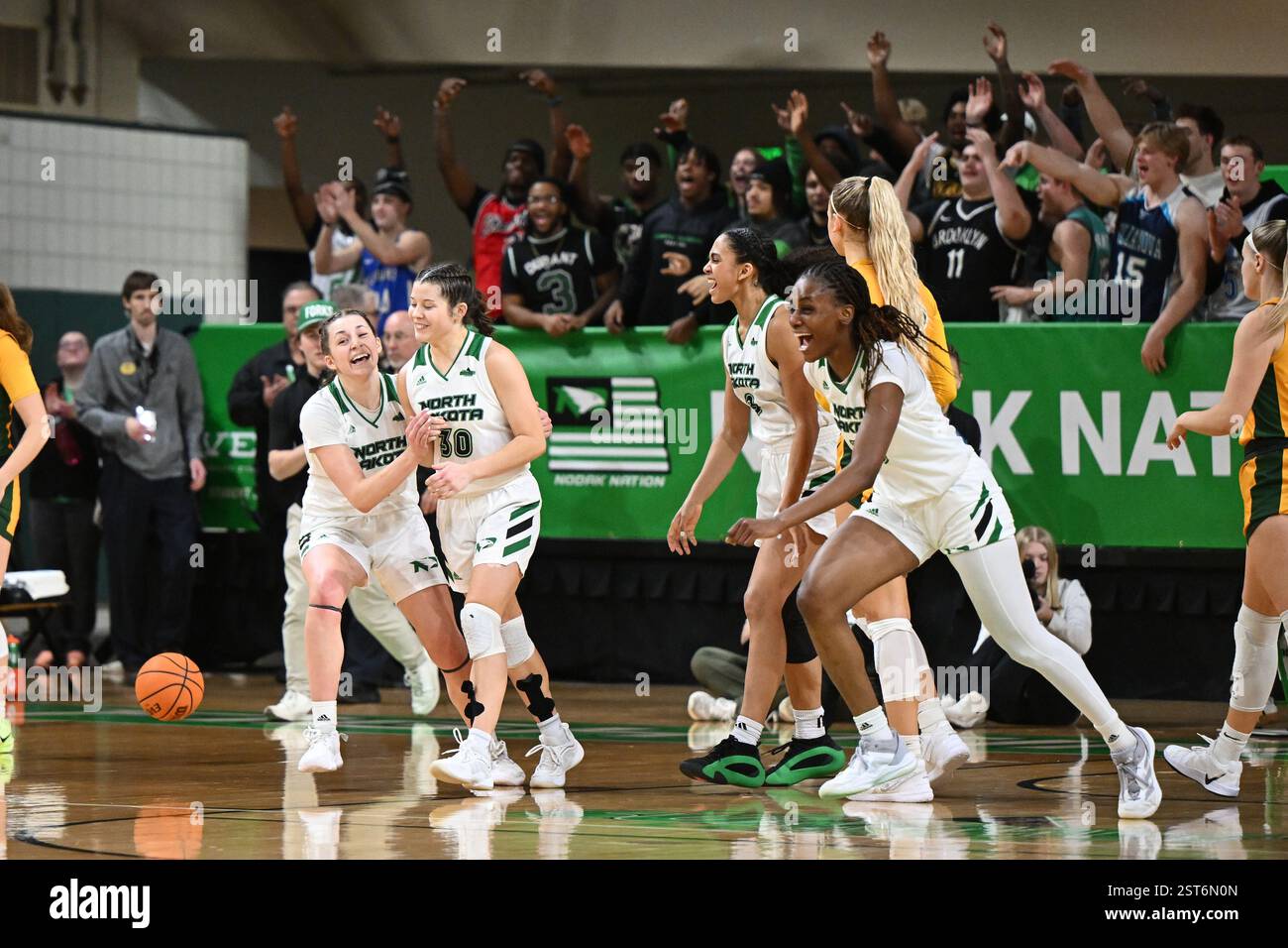 North Dakota players celebrate winning a NCAA women's basketball game ...