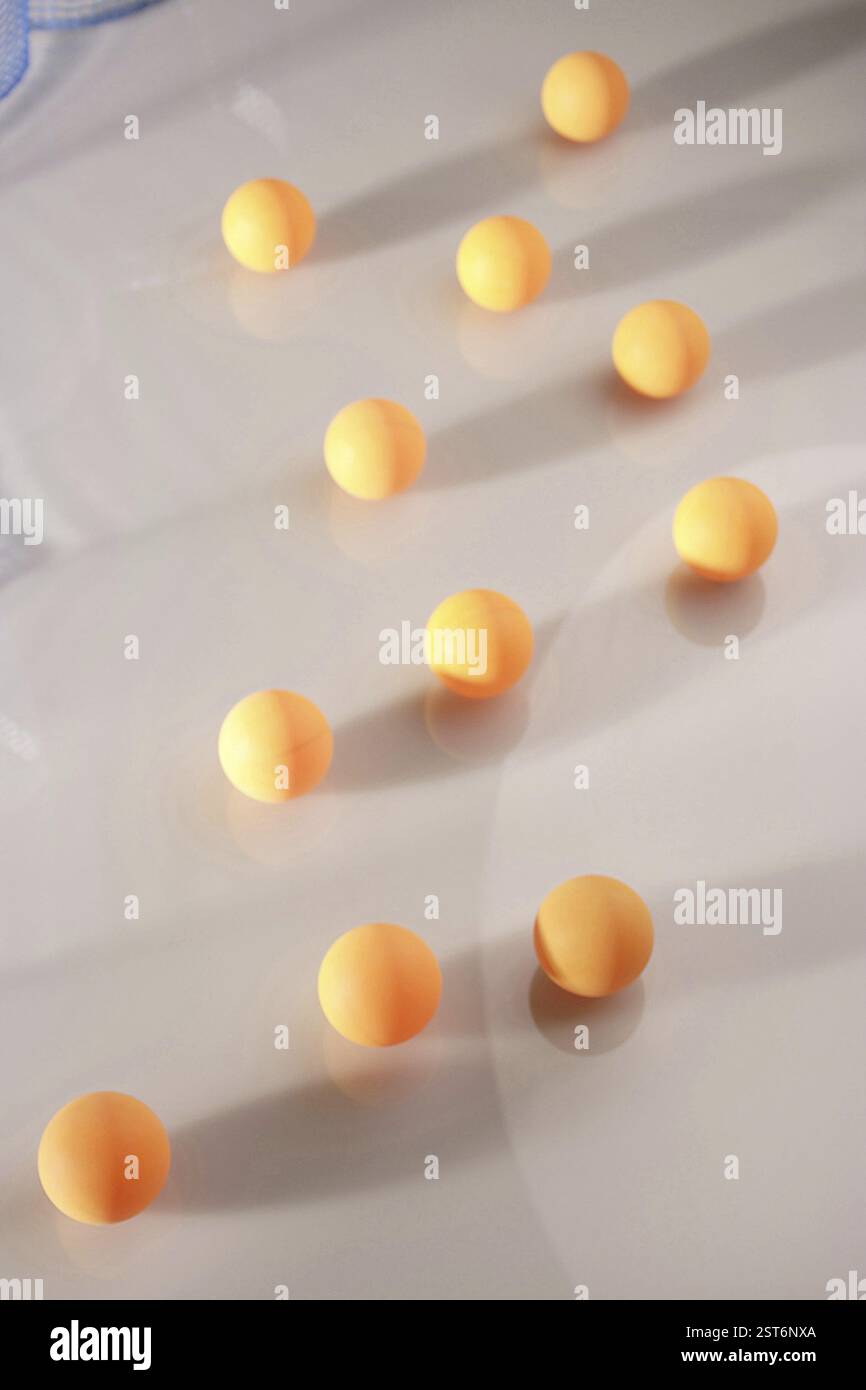 Table tennis eleven orange color balls Stock Photo - Alamy