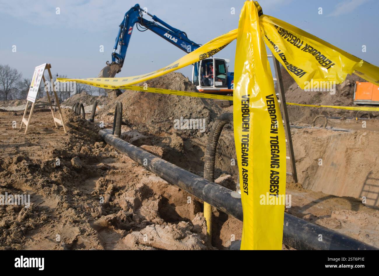 Asbestos removal and disposal of a pipeline. Remediation pipeline. Yellow warning ribbons Stock ...