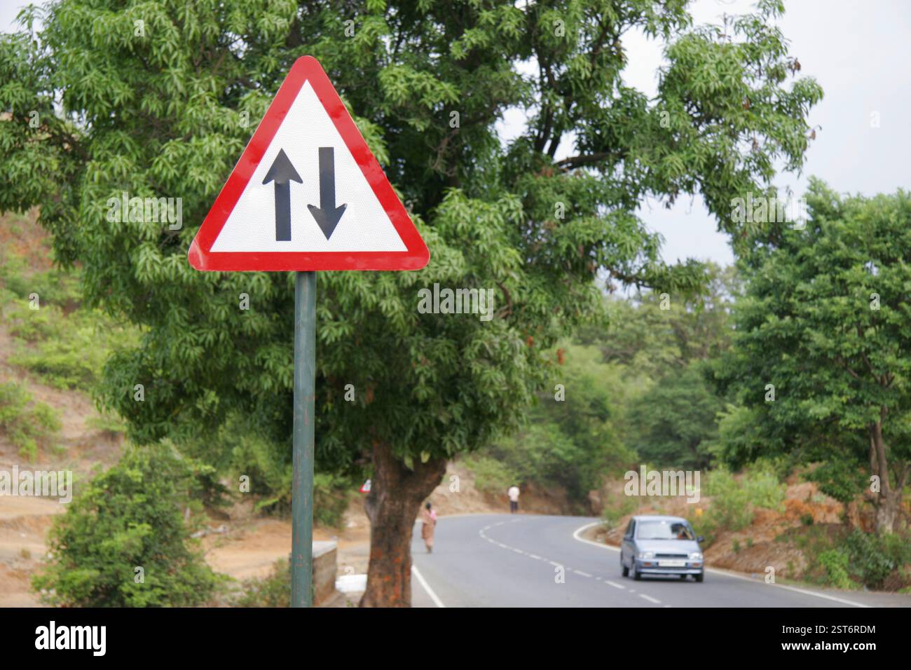 A road sign indicating two way lane Stock Photo - Alamy