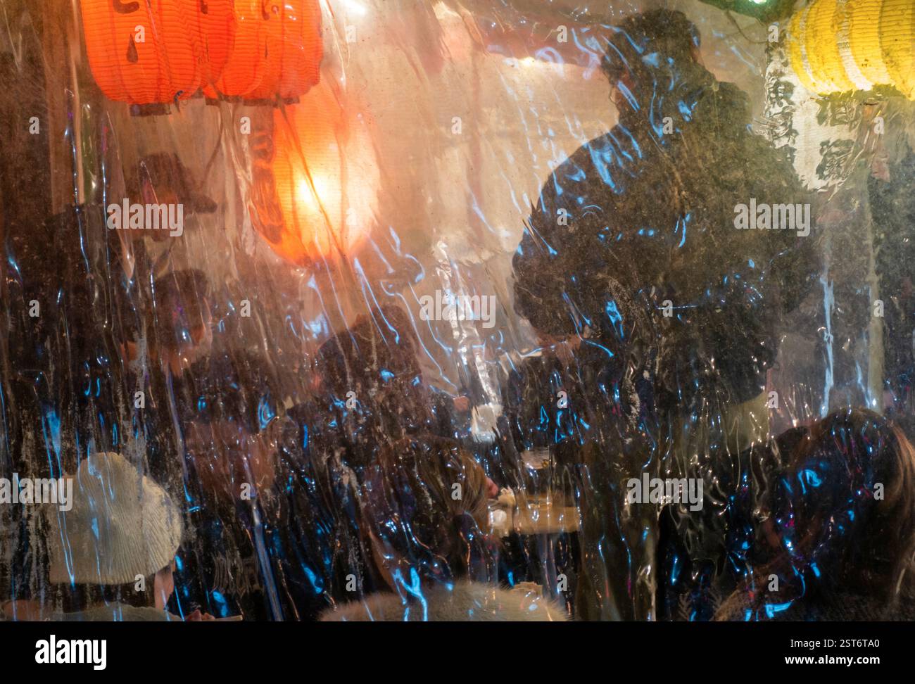 people eating in sidewalk restaurants in the rain in Asakusa Tokyo ...