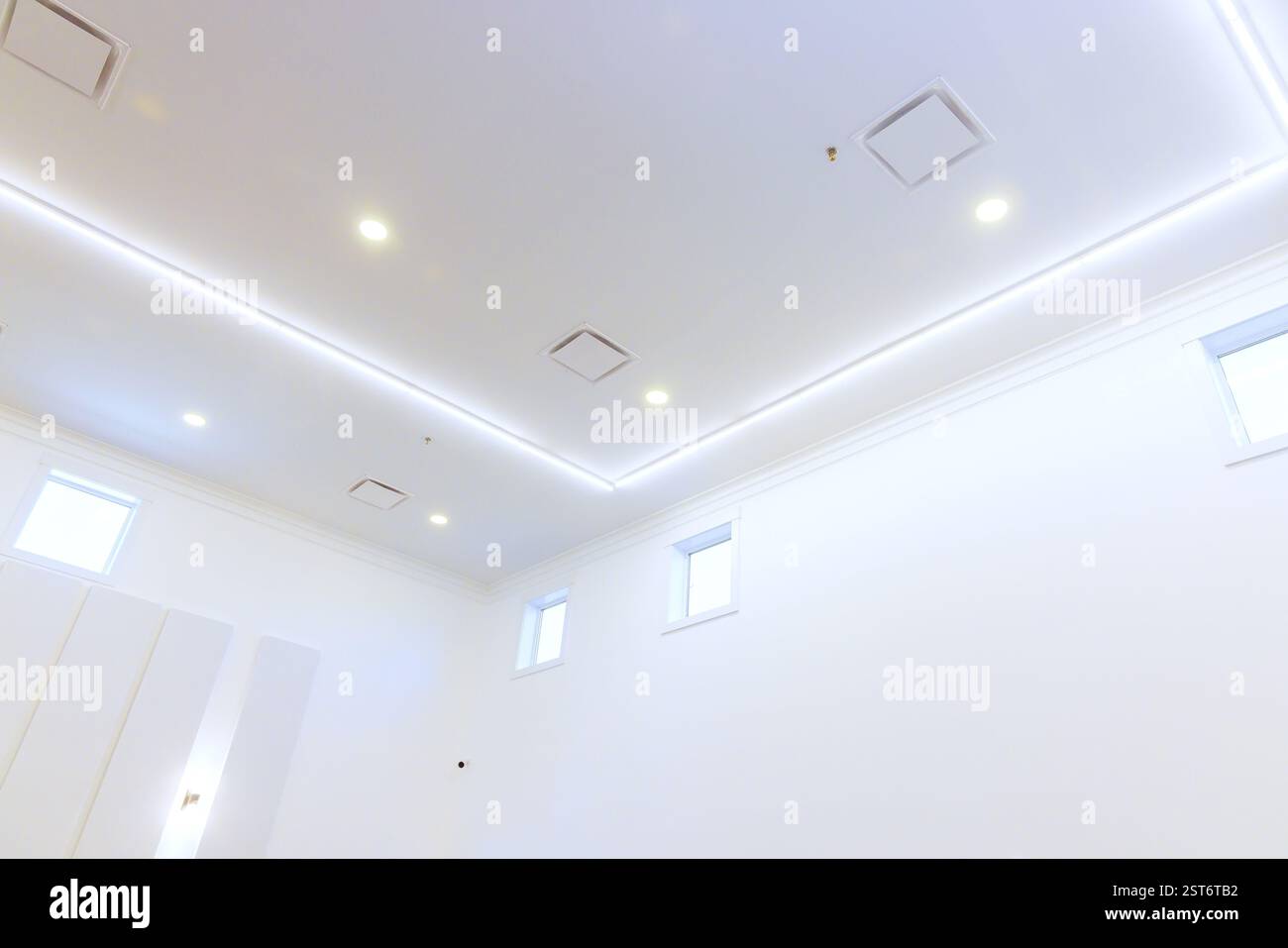Spacious, well lit room with sleek white ceiling showcasing recessed ...
