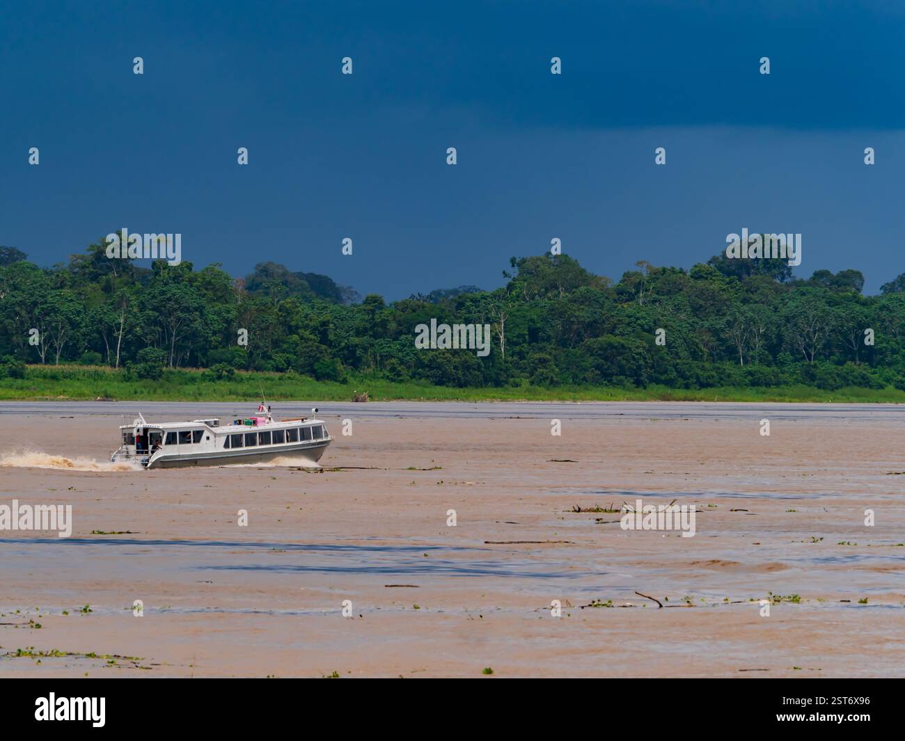 A small speedboat on the rough waters of the Amazon River. Amazonia ...