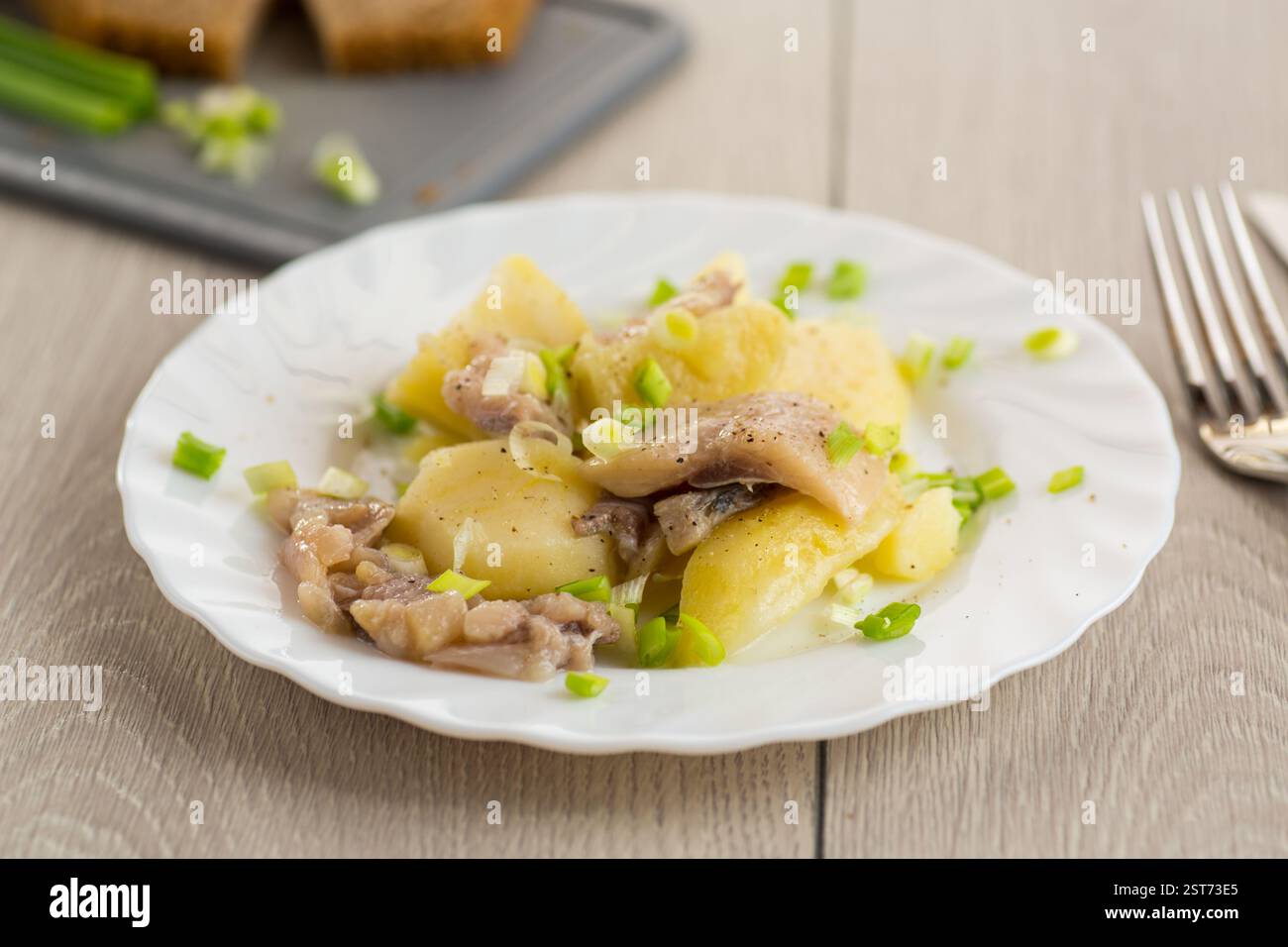 Homemade potatoes with aromatic fish Stock Photo - Alamy