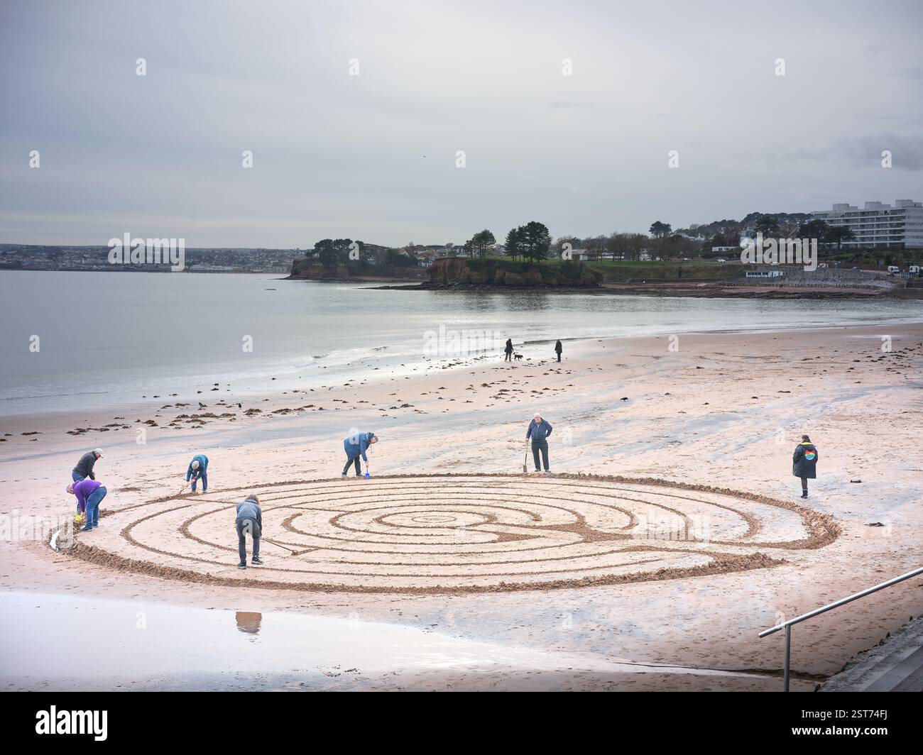 Building a maze on the beach of Torre Abbey Sands, Devon, England, with ...