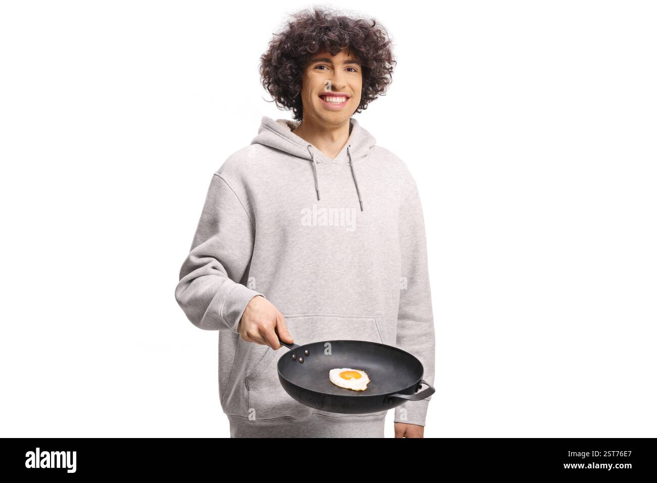 Guy frying an egg in a pen isolated on white background Stock Photo - Alamy