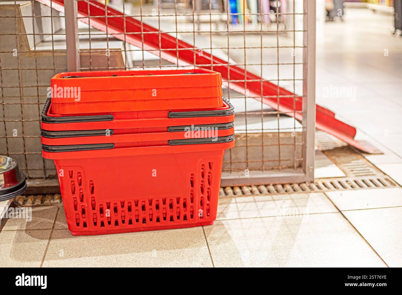plastic baskets for food and things are on the floor at the entrance to ...