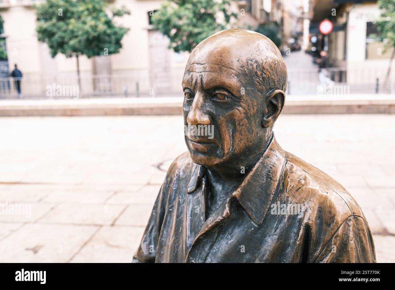 Life-size bronze statue of Pablo Picasso on a marble bench in Plaza de ...