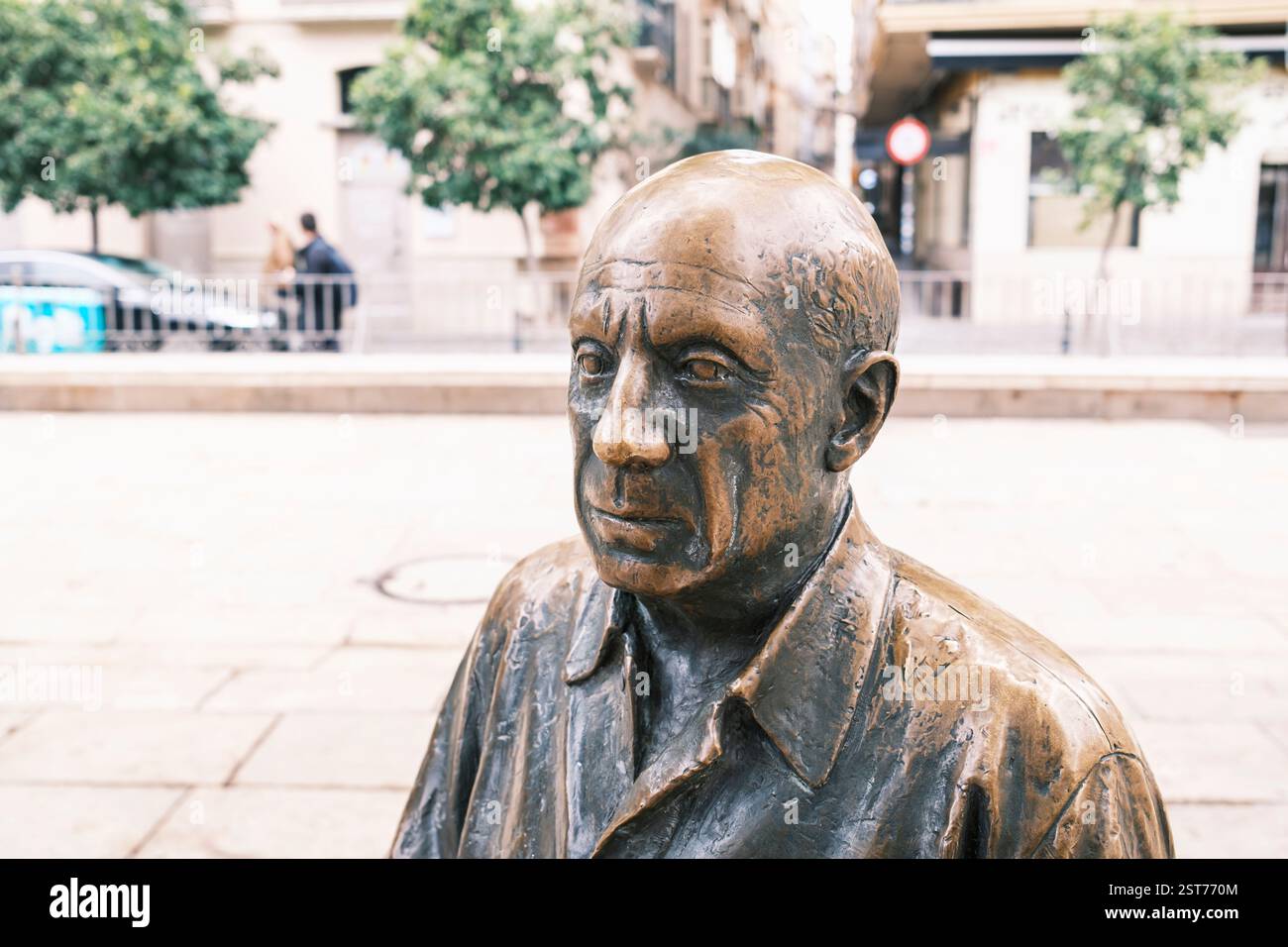 Life-size bronze statue of Pablo Picasso on a marble bench in Plaza de ...