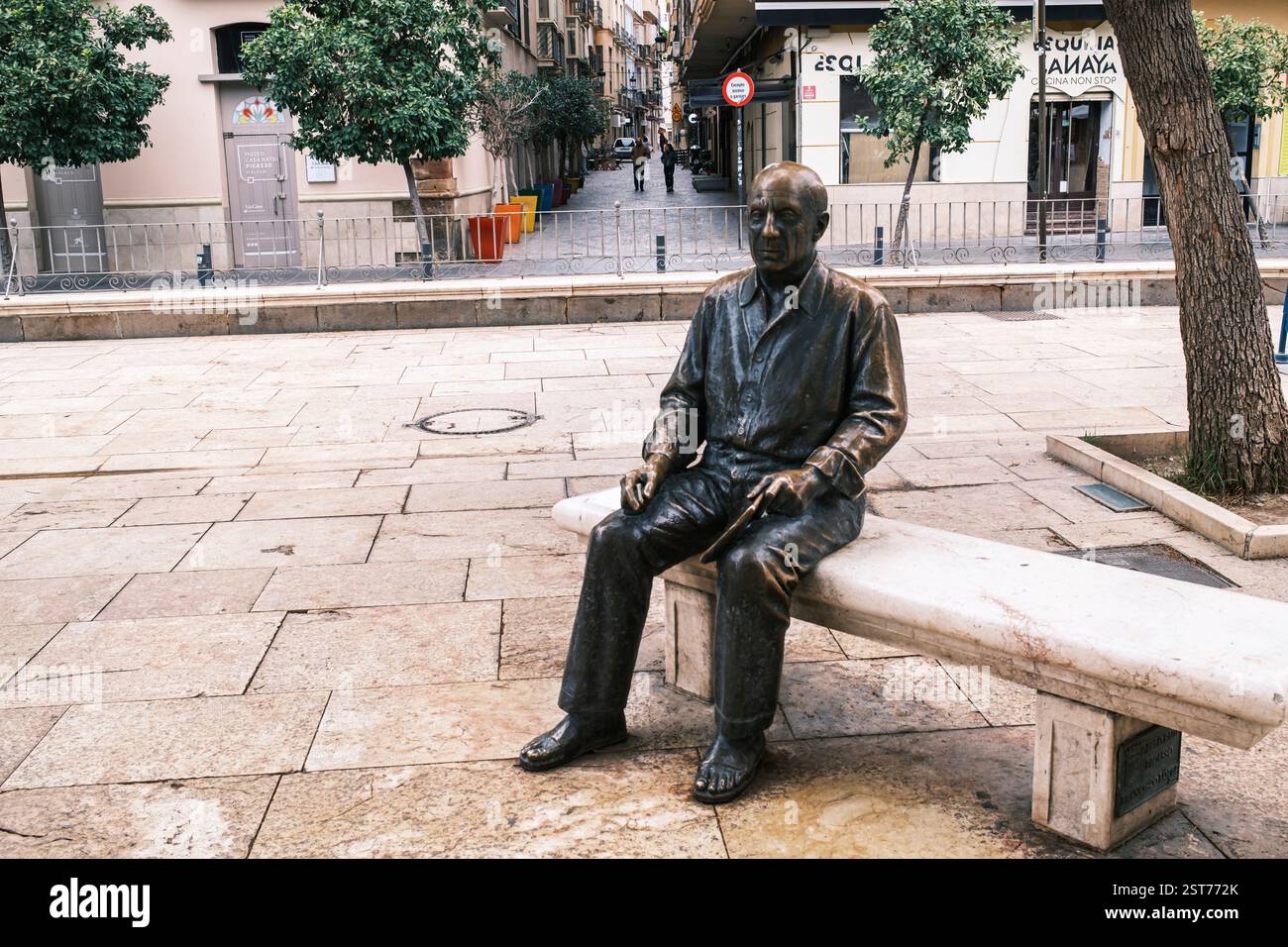 Life-size bronze statue of Pablo Picasso on a marble bench in Plaza de ...