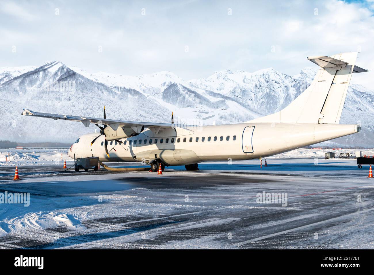 White passenger turboprop airplane on the winter airport on the ...