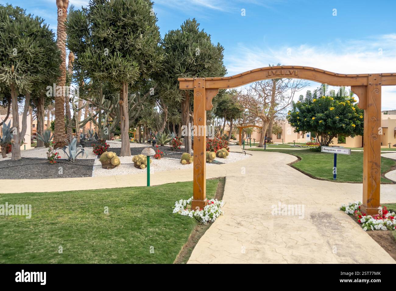 Beautiful landscaped garden pathway in Egypt surrounded by tropical ...