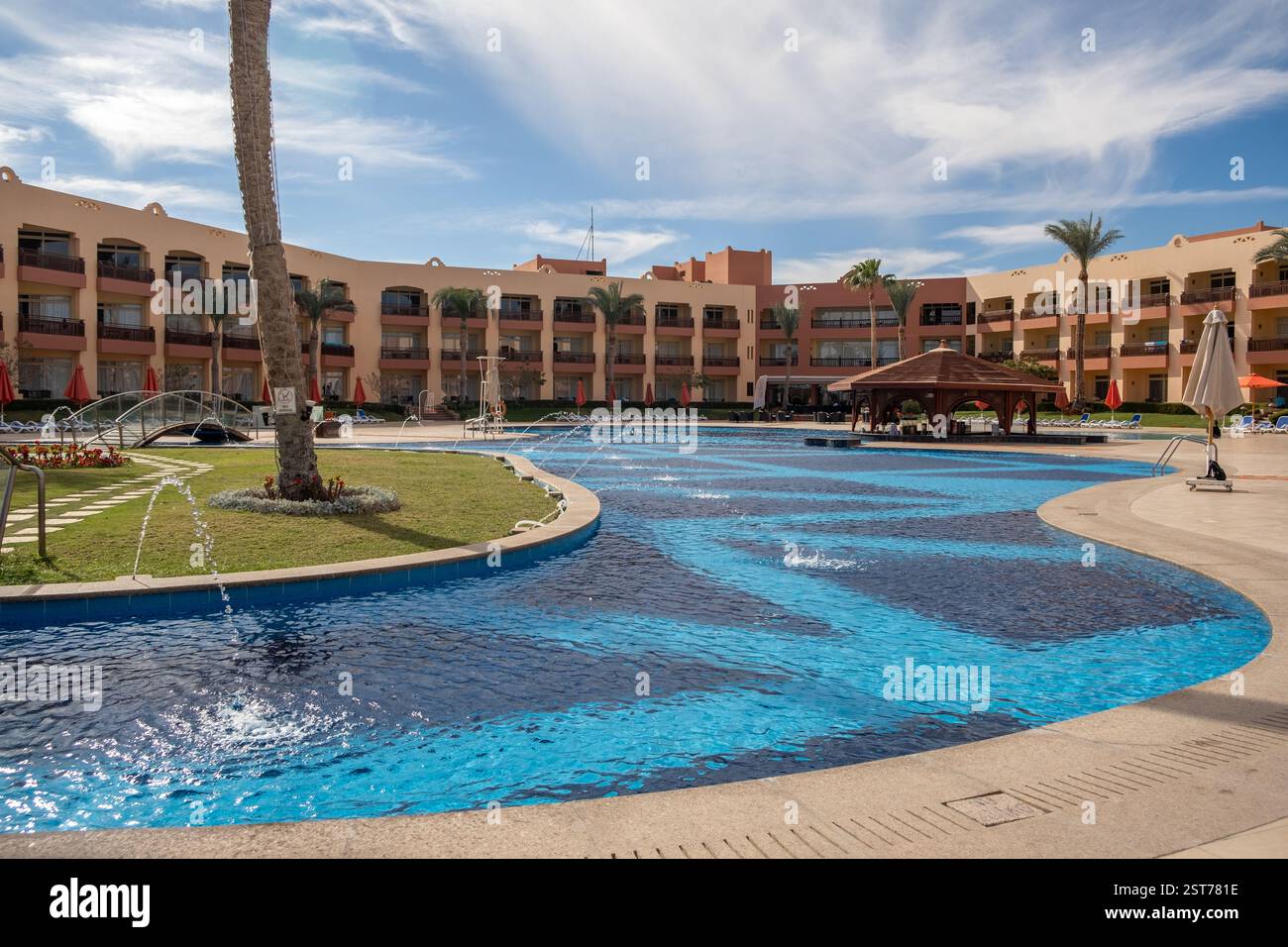 Beautiful resort pool area in Egypt with palm trees and clear blue ...