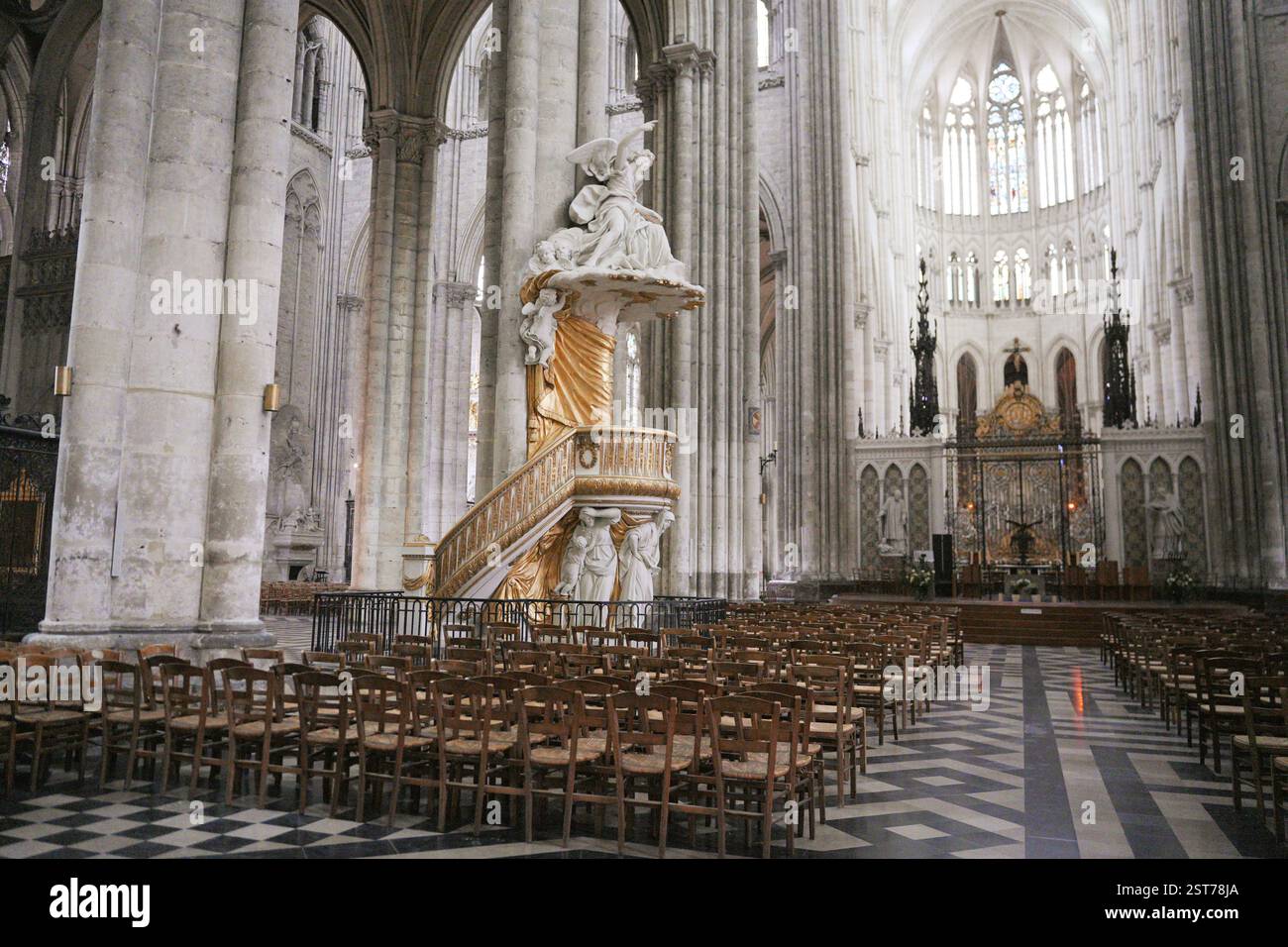 Interior of Cathedral, highlighting a golden pulpit with angel sculptures, Gothic columns ...