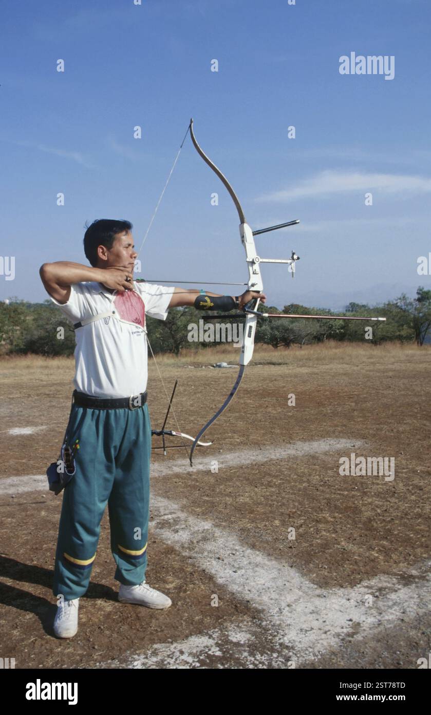 Professional archer with re-curve bow arrow and target Stock Photo - Alamy