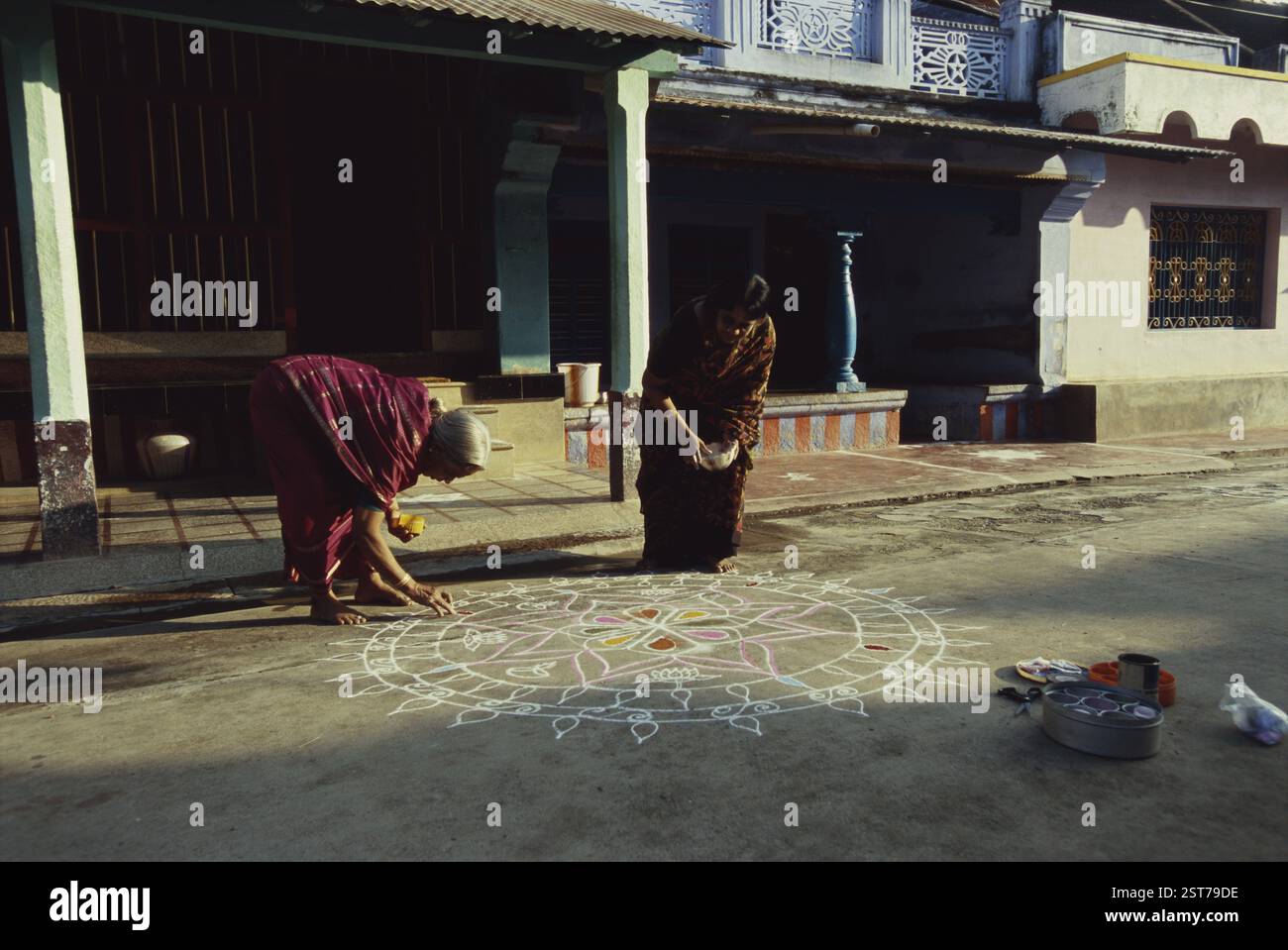 Brahmin women making kolam at Sundarapandyapuram, Agraharam, Tamil Nadu ...