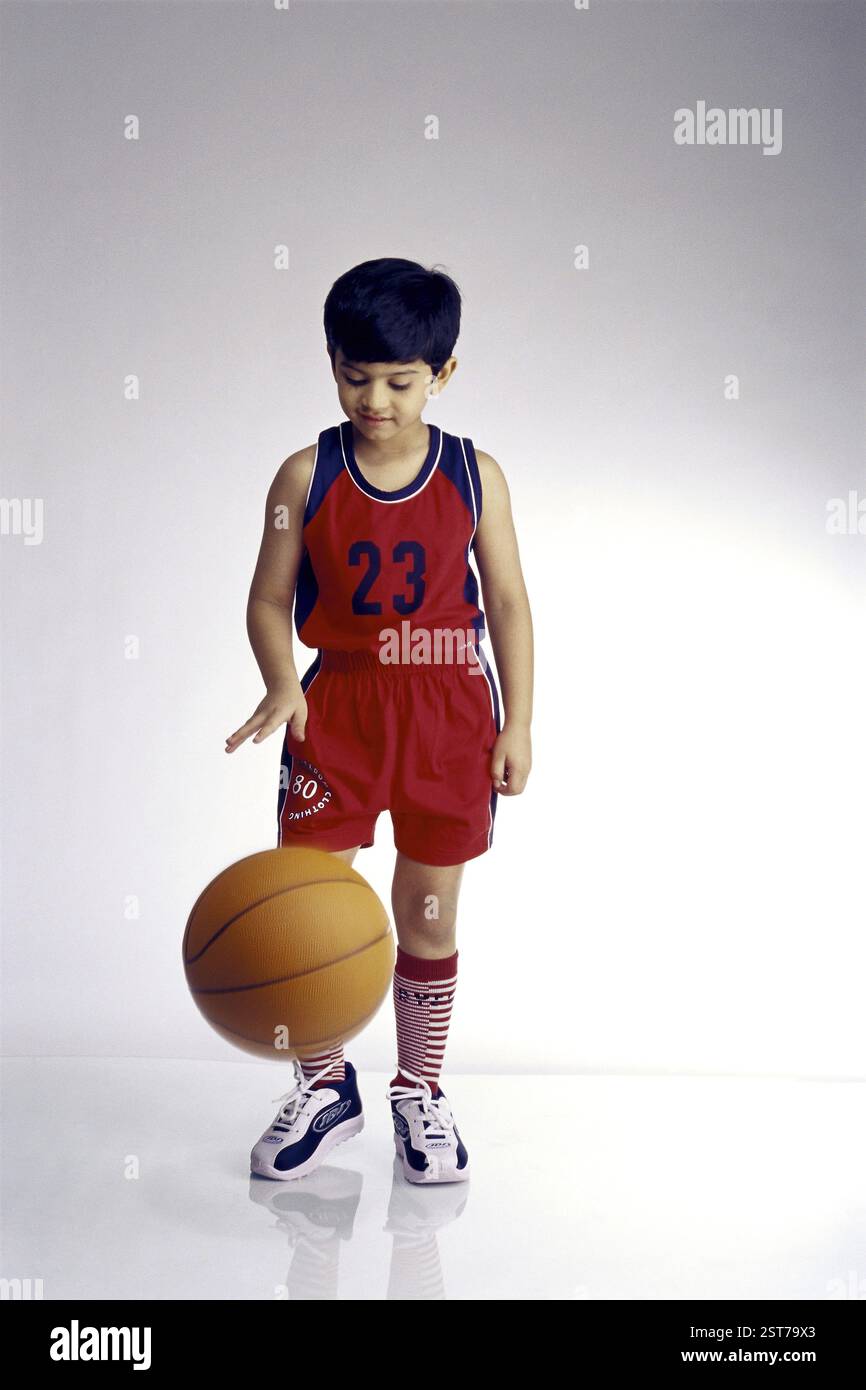 Child dressed as Basketball Player Playing With Basketball Wearing ...