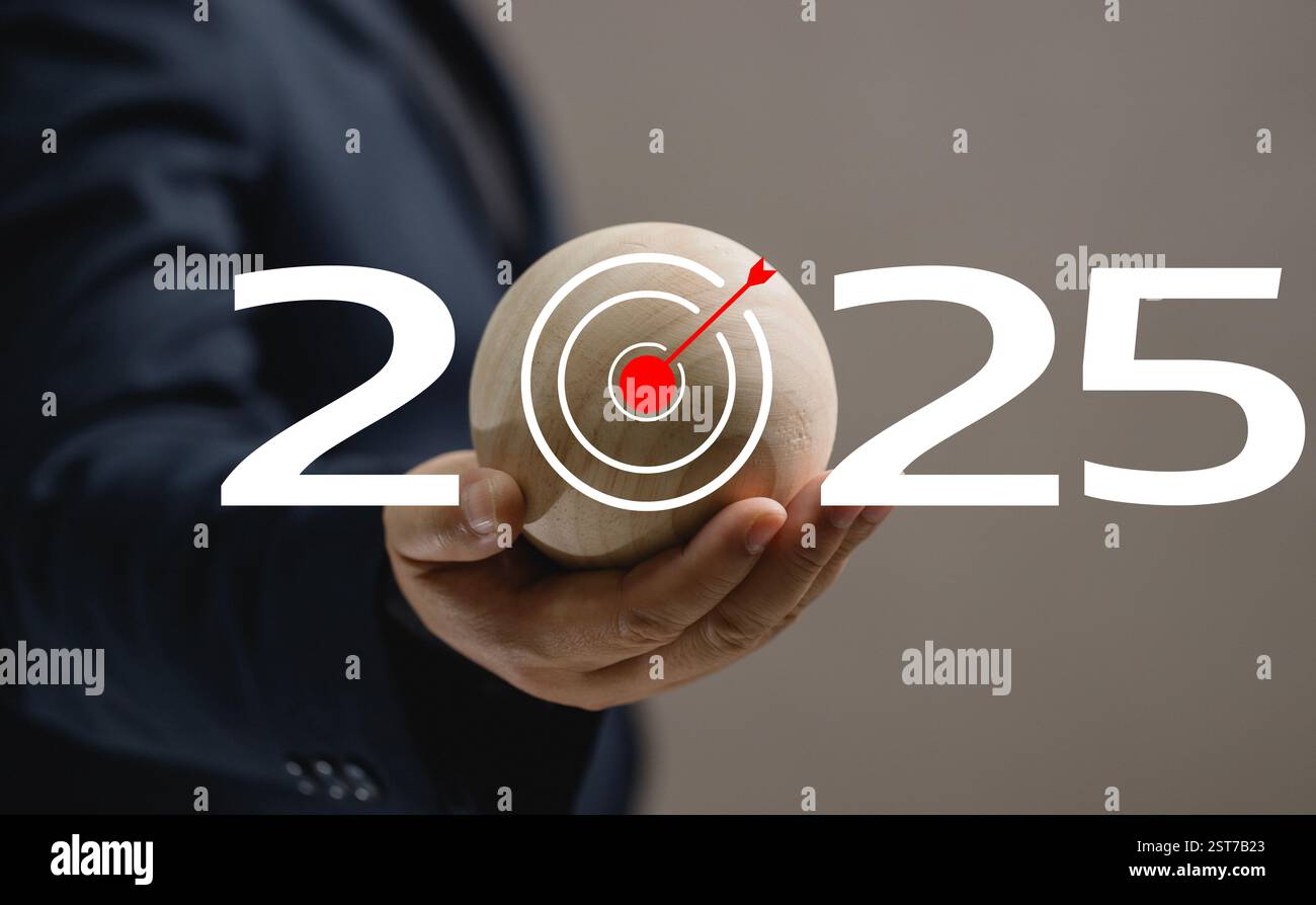 man hold the marketing 2025 icon in hand. business target for success ...