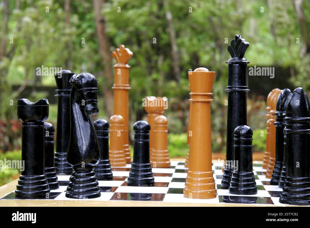 A chess board with its pieces. The chess board is made of ceramic tiles ...
