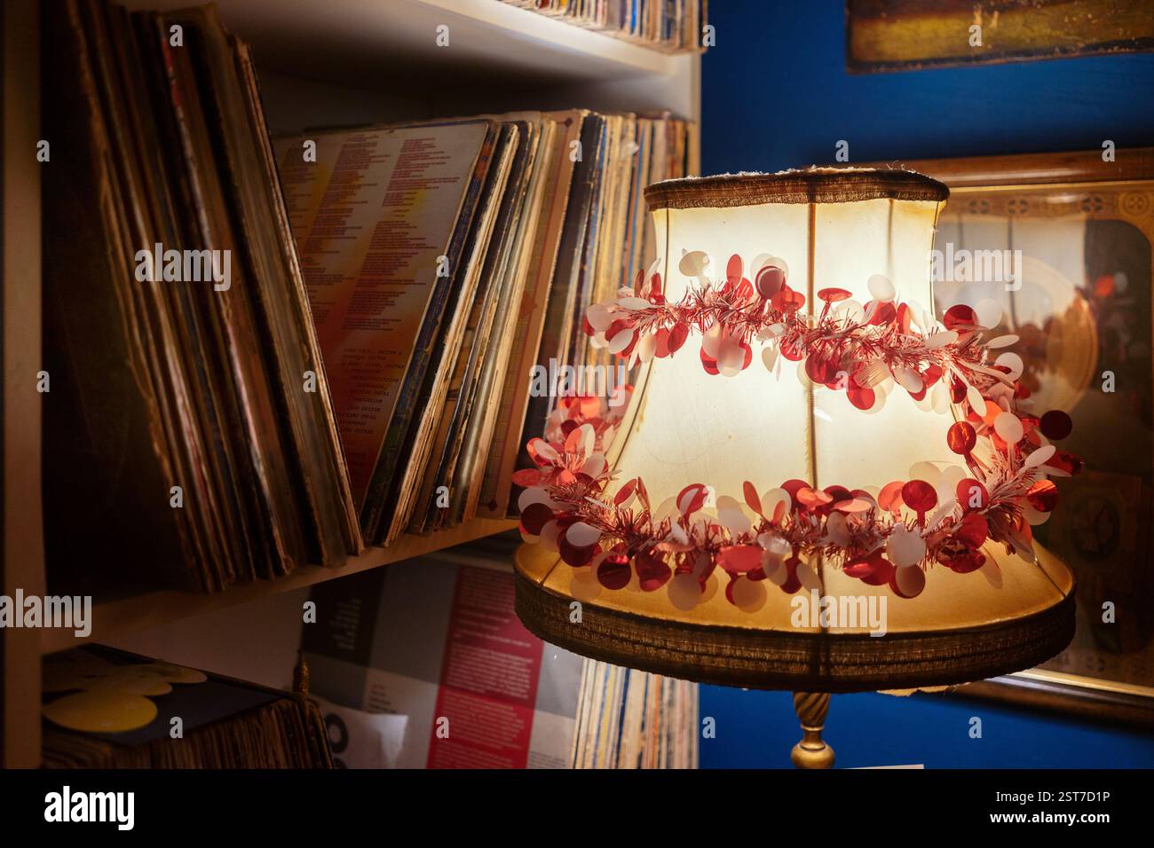 Details of an old decorative lamp next to a cabinet with vinyl records ...