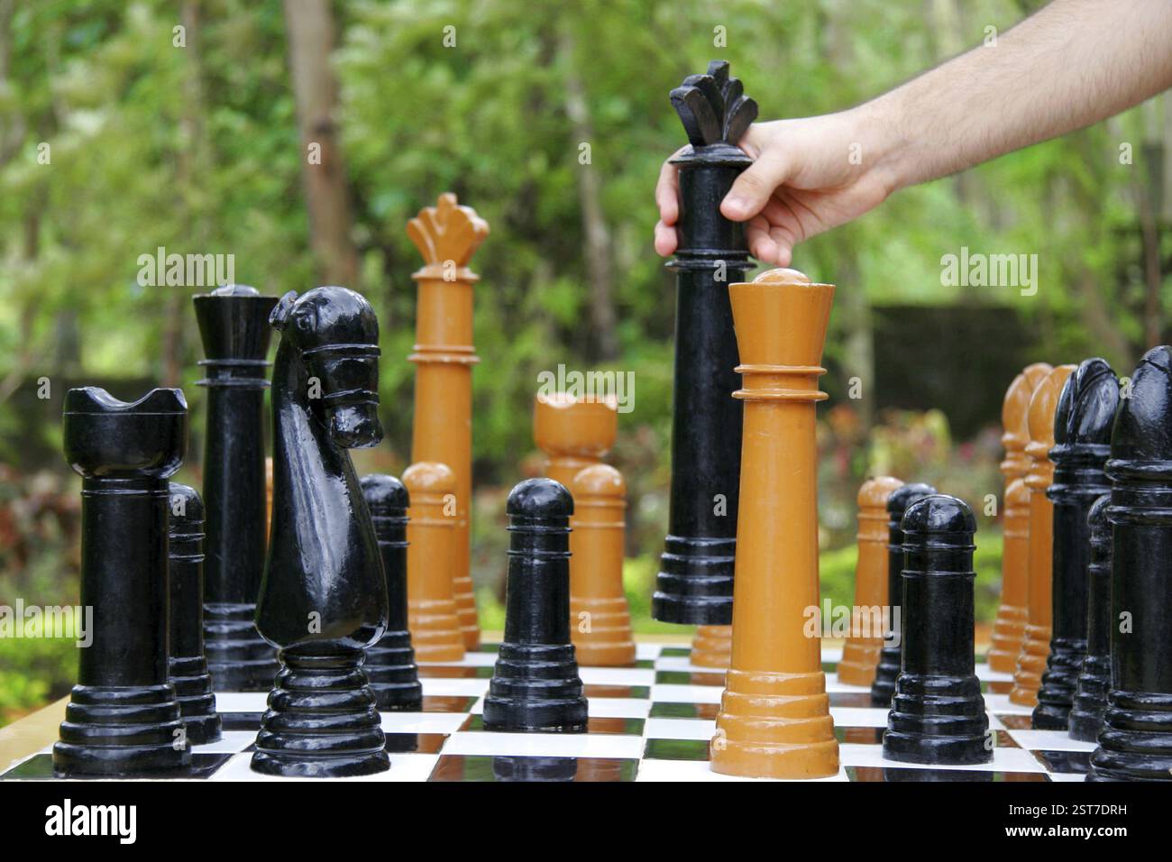 A chess board with its pieces. The chess board is made of ceramic tiles ...