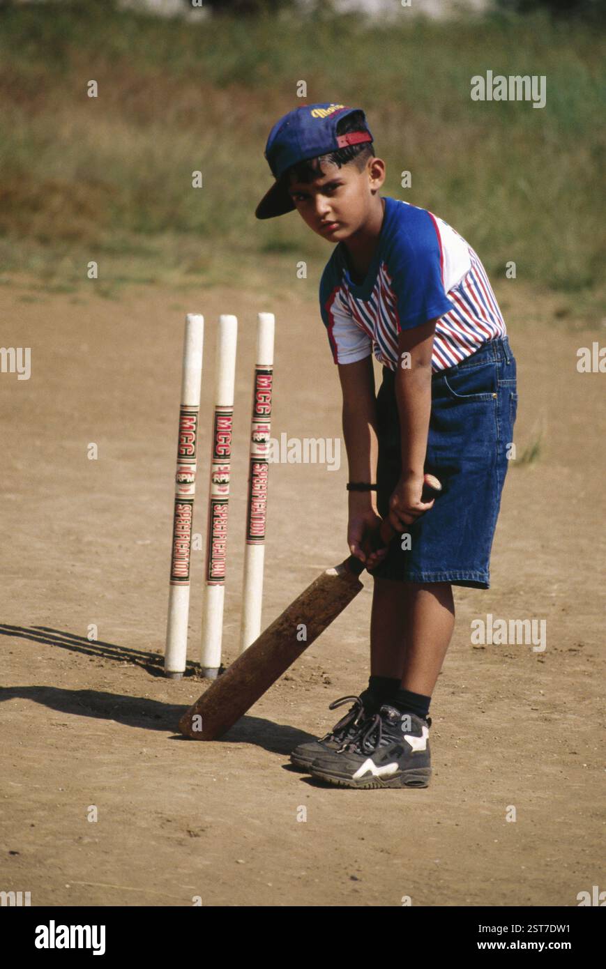 South Asian Indian boy playing cricket MR#158 Stock Photo - Alamy