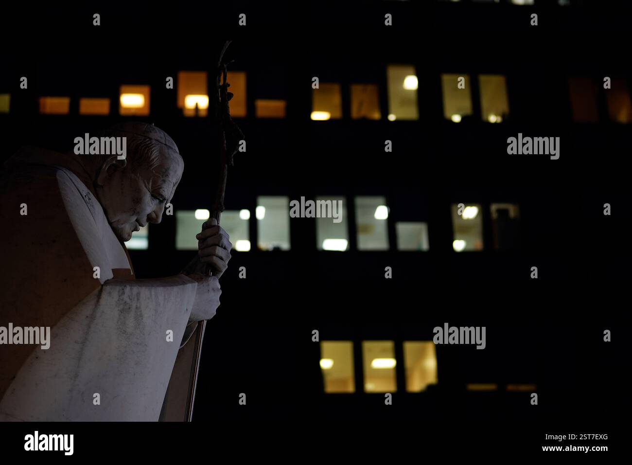 A marble statue of late Pope John Paul II is backdropped by the ...