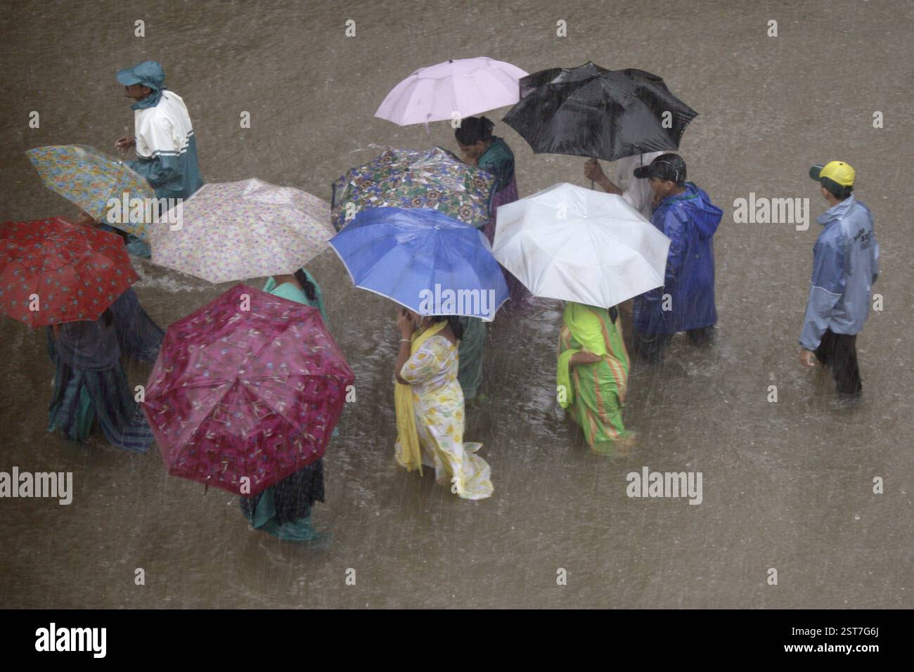 Showing People are walking with color umbrella in flooded water ...