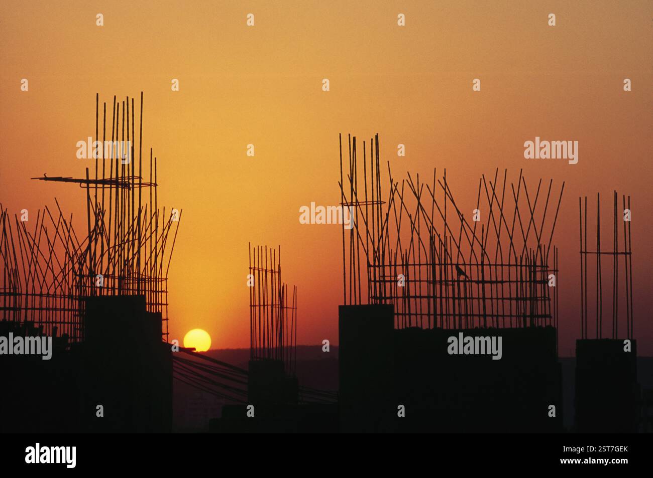 Sunset behind columns and bars, building under construction, pune ...