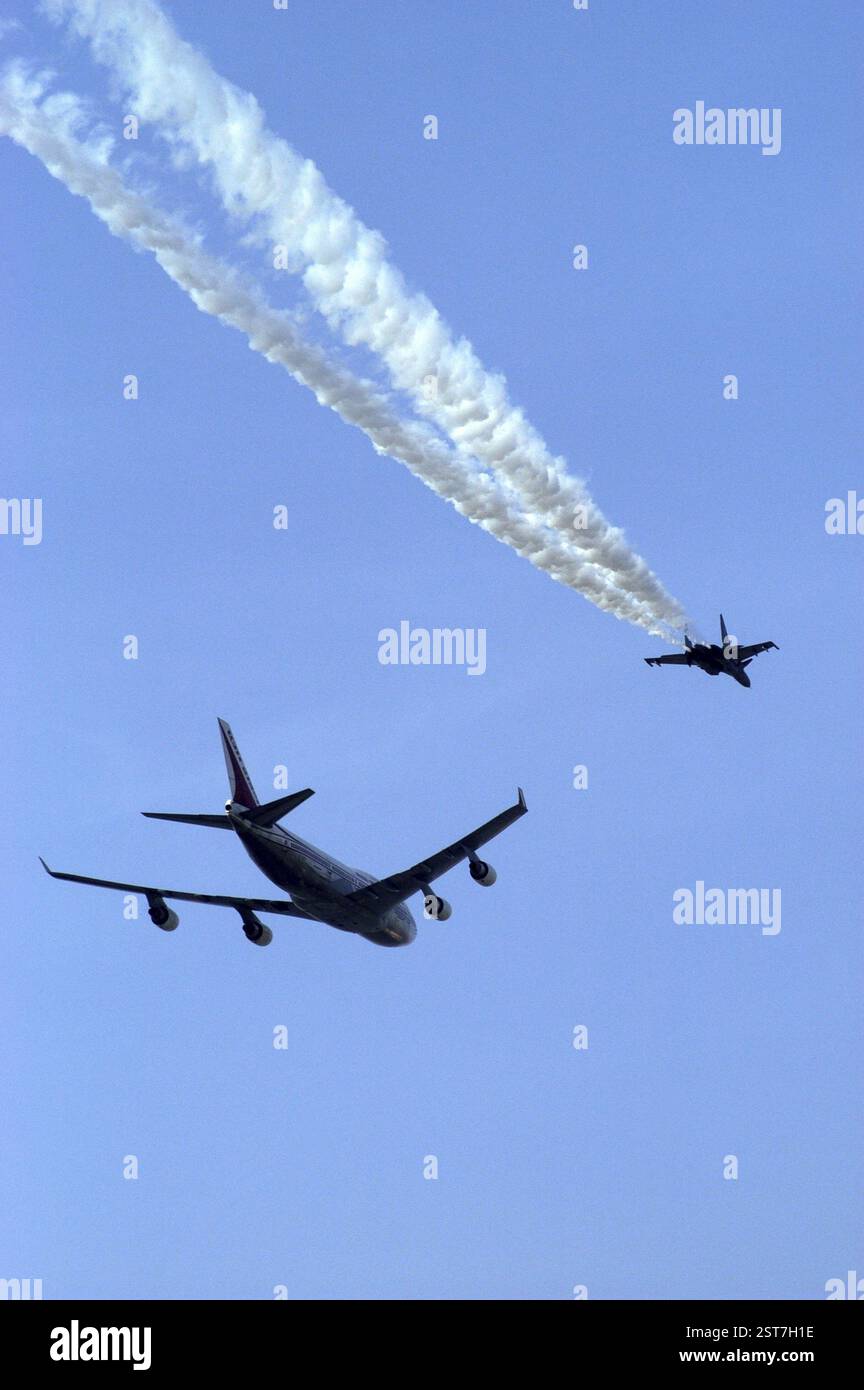 Commercial airliner fly past with fighter aircraft during air show by ...