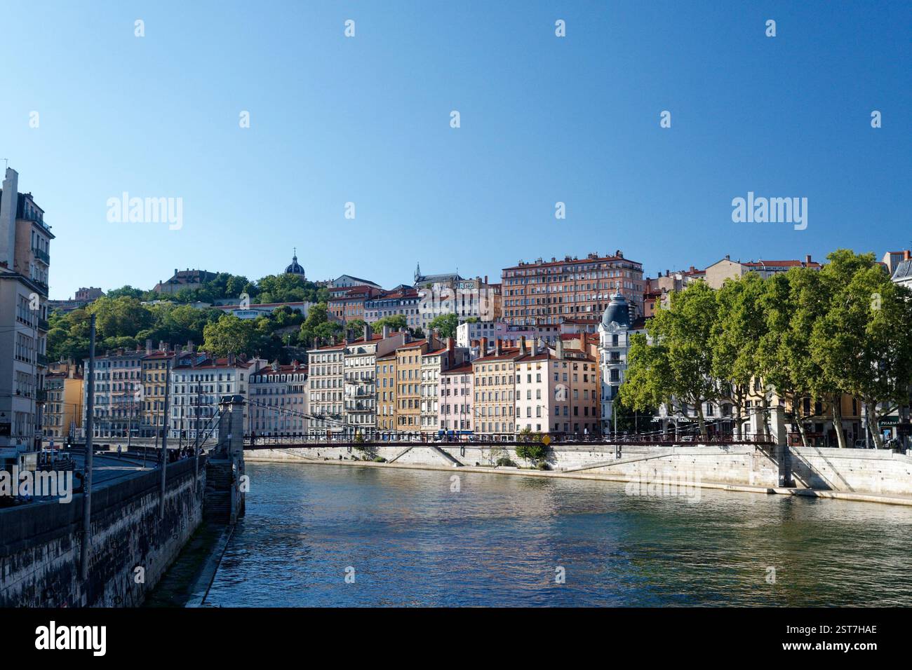 Water front with pedestrian bridge over the Saône river in Lyon, France ...