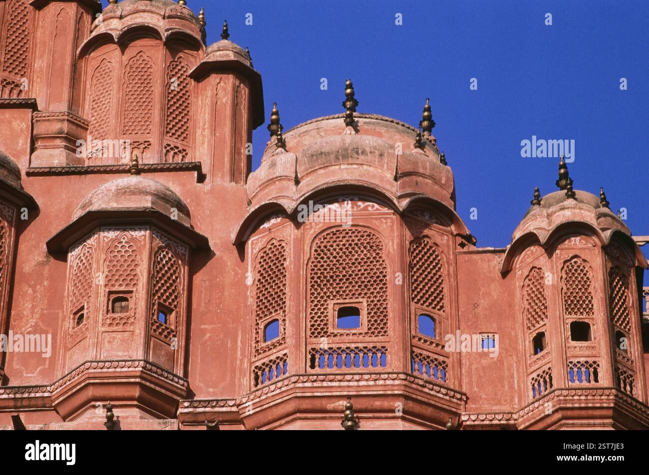 Rajasthani man viewing from window of Hawa Mahal Palace of wind, Jaipur ...